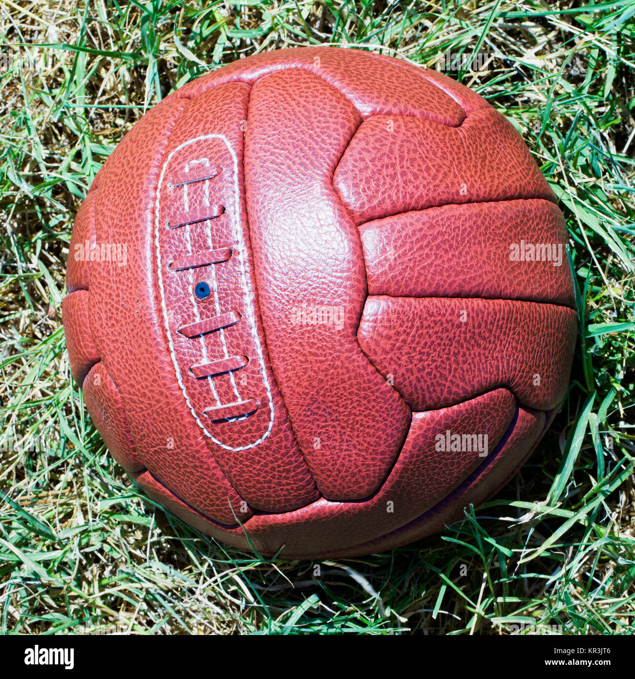Vintage football over grass field Stock Photo - Alamy