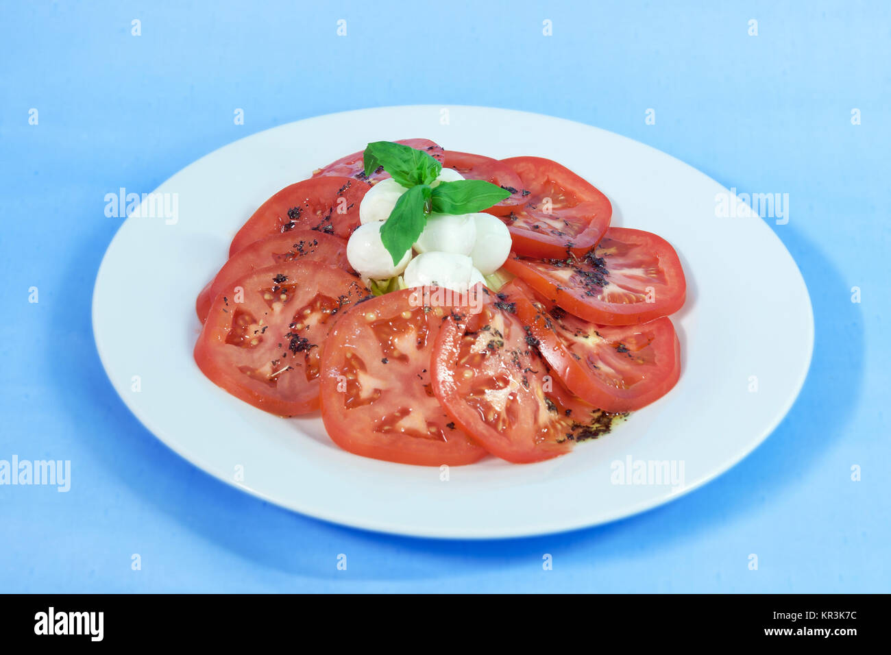 Modern food on a white plate and blue background Stock Photo - Alamy