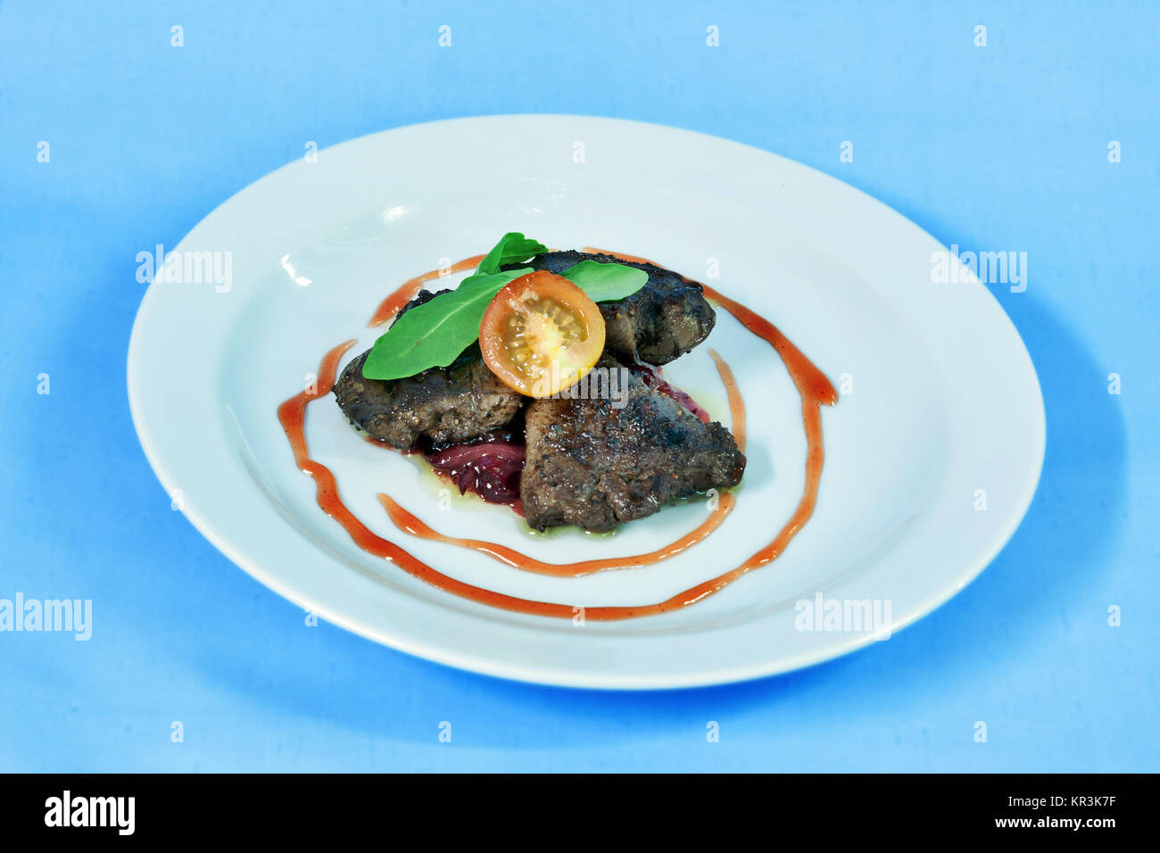Modern food on a white plate and blue background Stock Photo - Alamy
