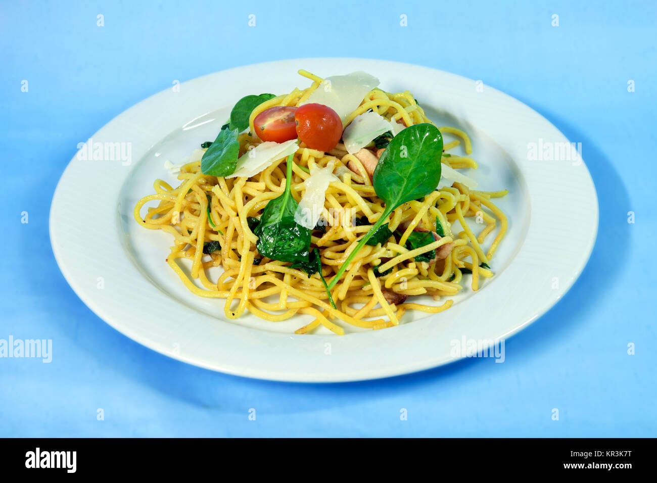 Modern food on a white plate and blue background Stock Photo - Alamy