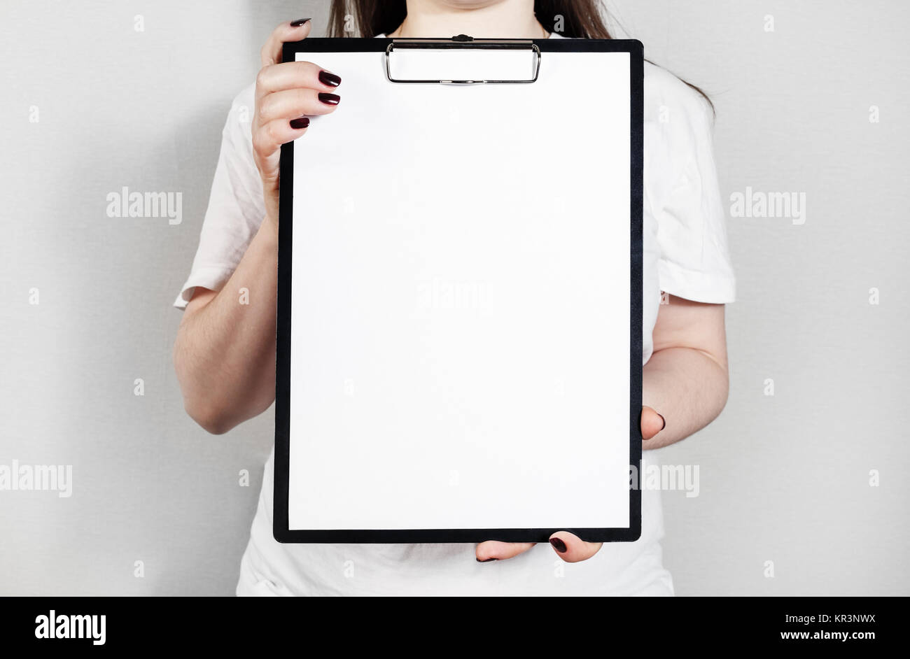 Woman holding clipboard Stock Photo - Alamy
