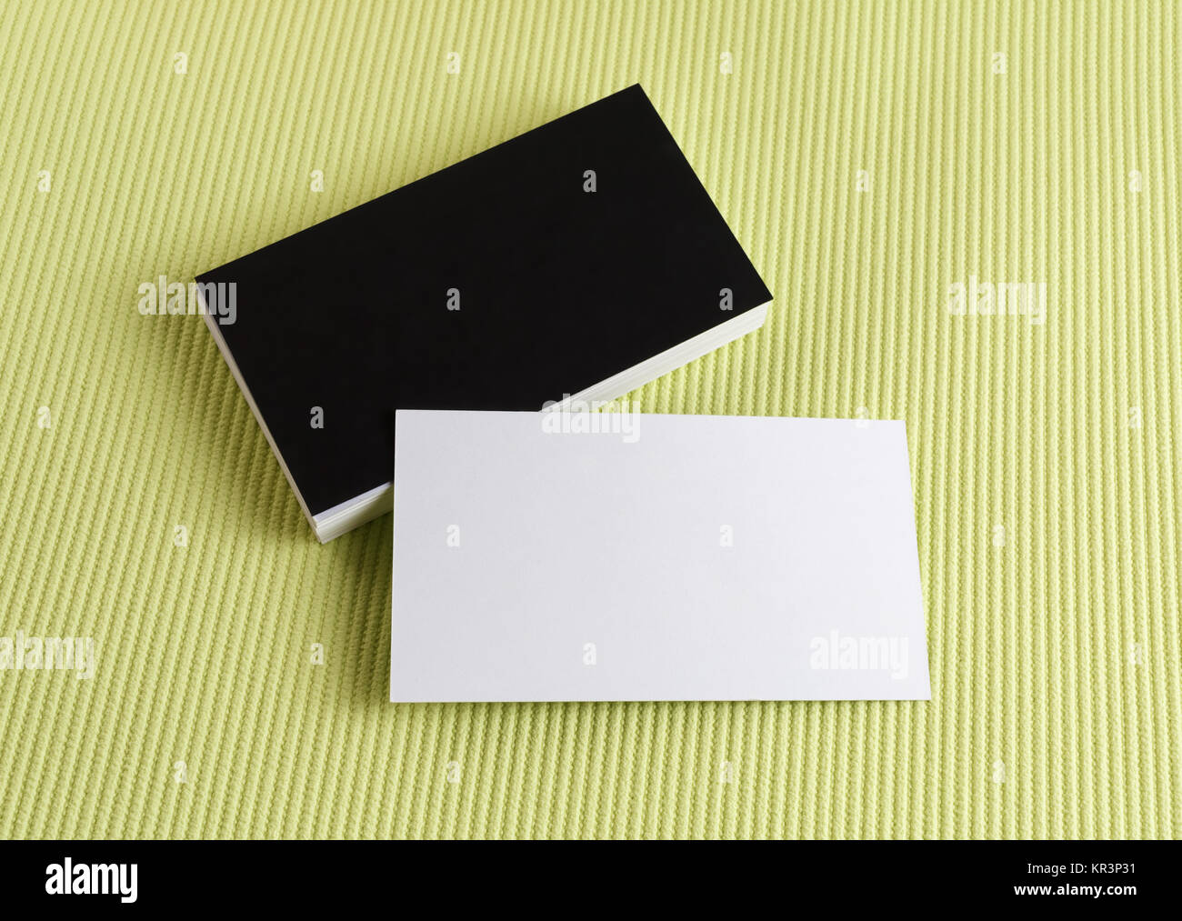 Business cards on a green background Stock Photo - Alamy