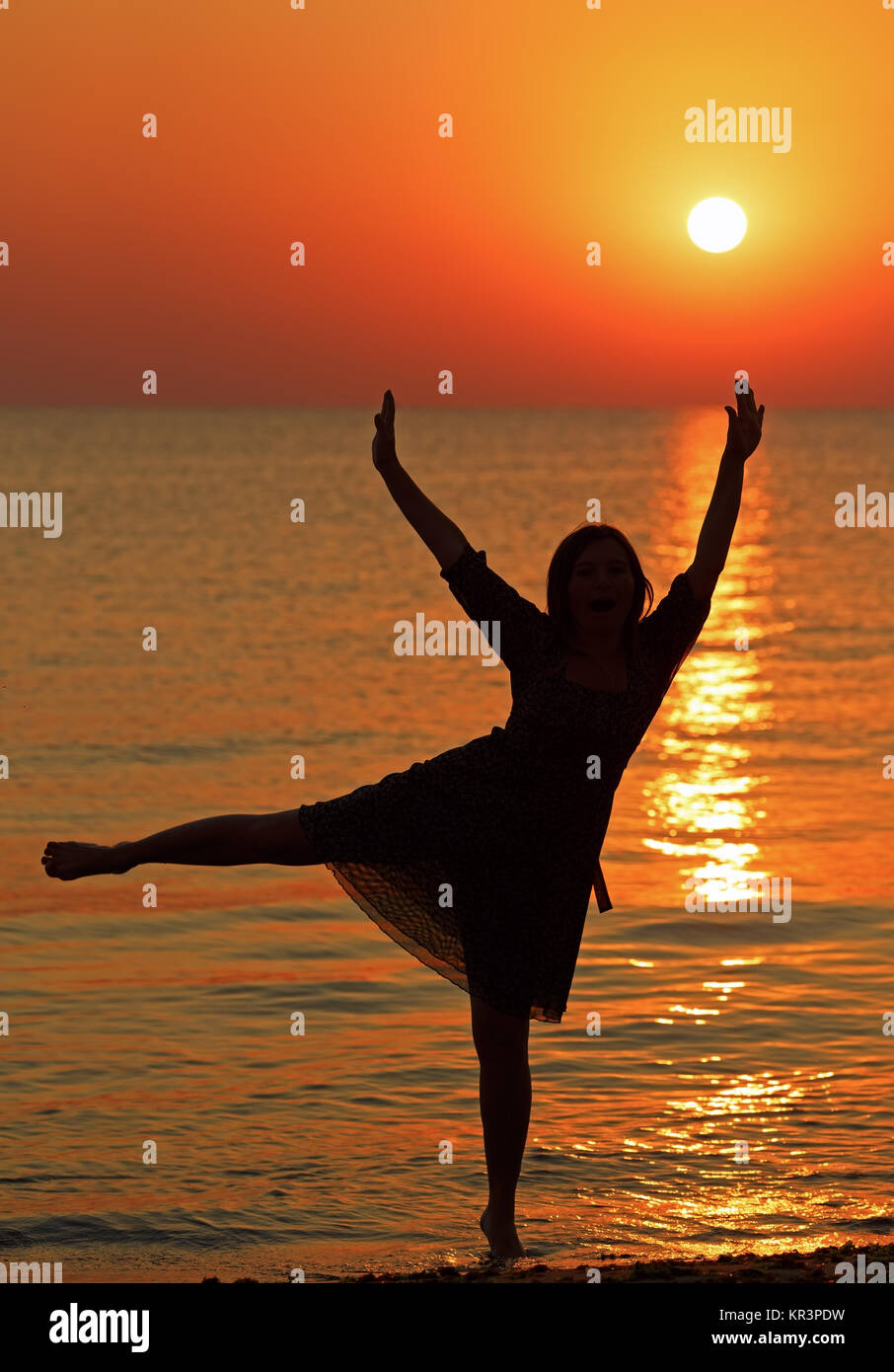 Girl dancing on the background of sunrise Stock Photo - Alamy