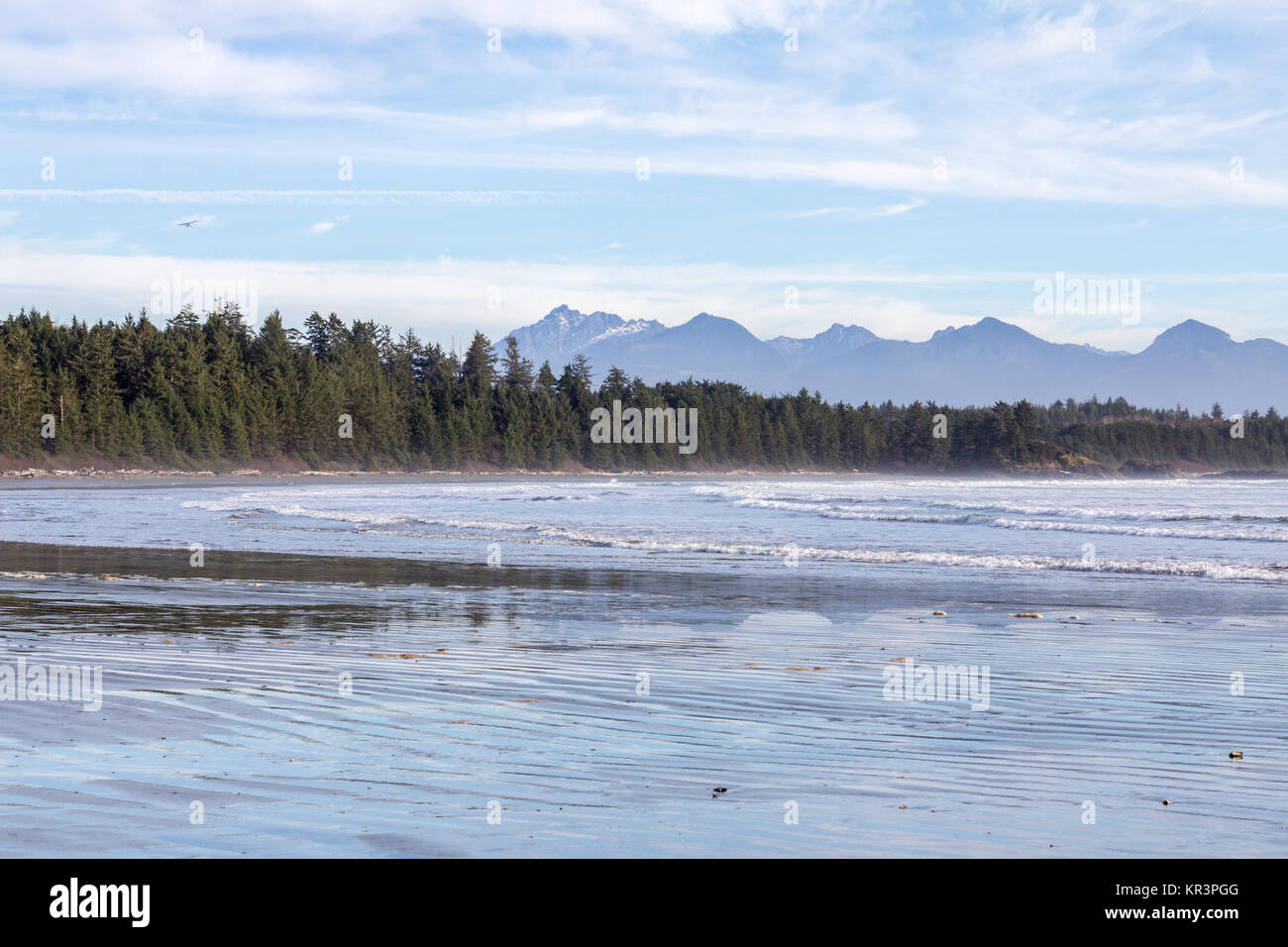 Backed by west coast rainforest and mountains, the receding tidal ...