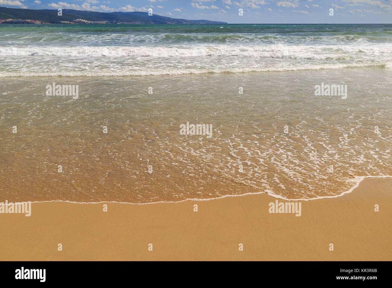 Sea surf on a sandy beach Stock Photo - Alamy