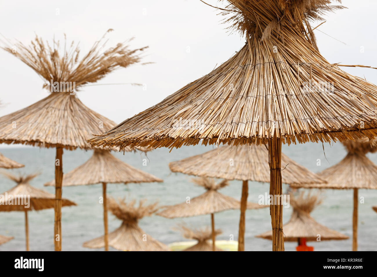 Straw beach umbrellas Stock Photo - Alamy