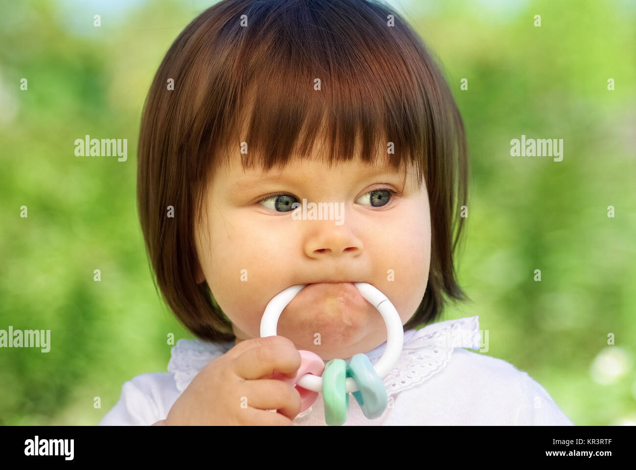 Baby with rattle Stock Photo - Alamy