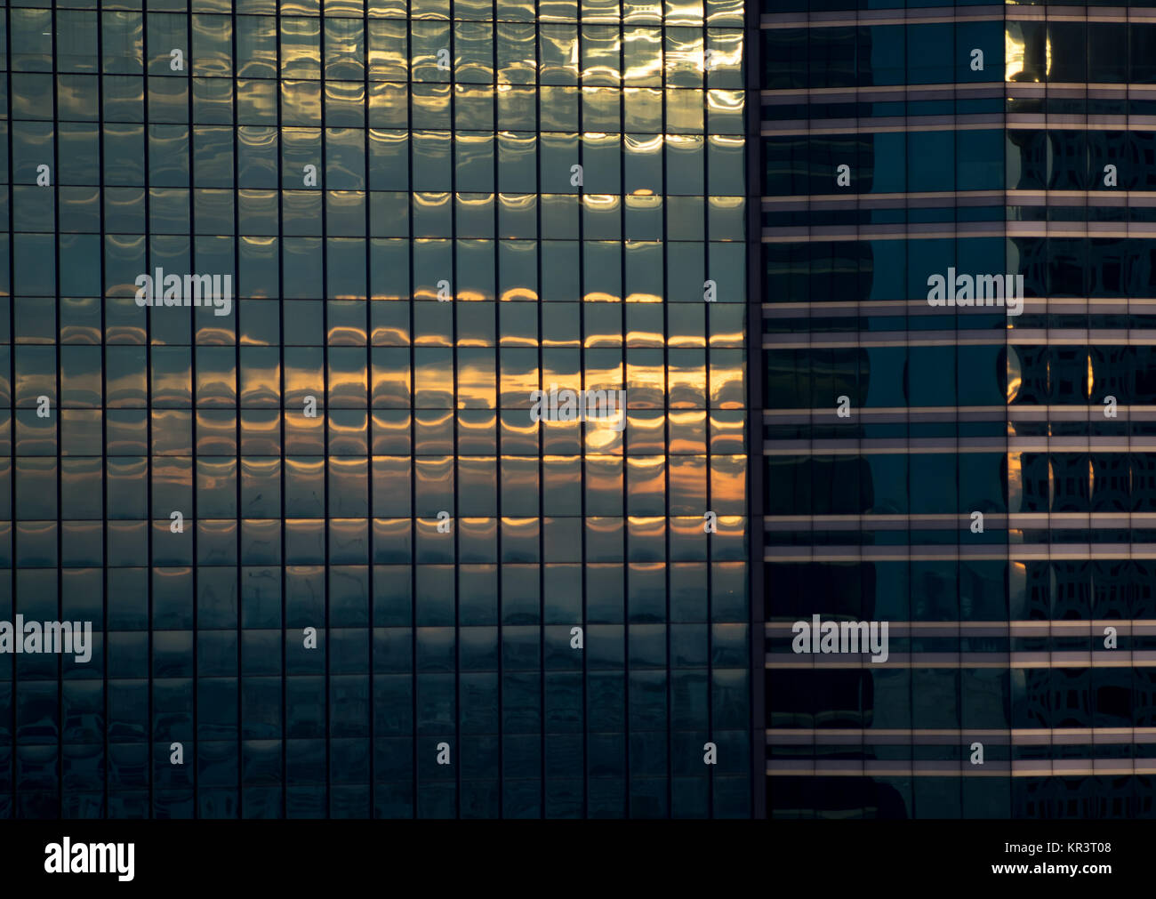 sunrise or sunset reflecting off the glass windows facade on a high ...