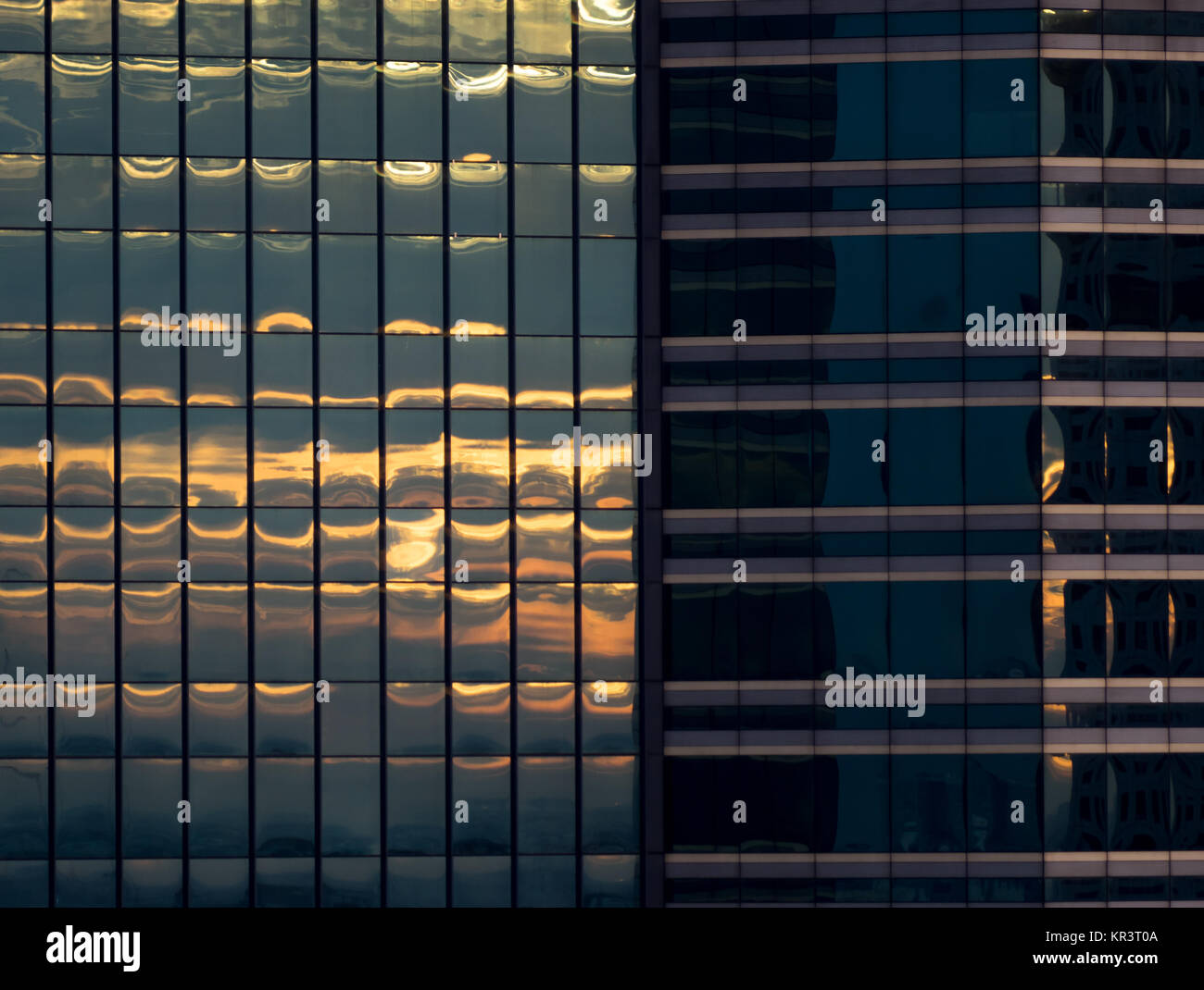 sunrise or sunset reflecting off the glass windows facade on a high ...