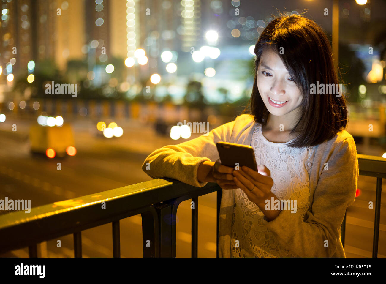 Woman use of mobile phone at night Stock Photo - Alamy
