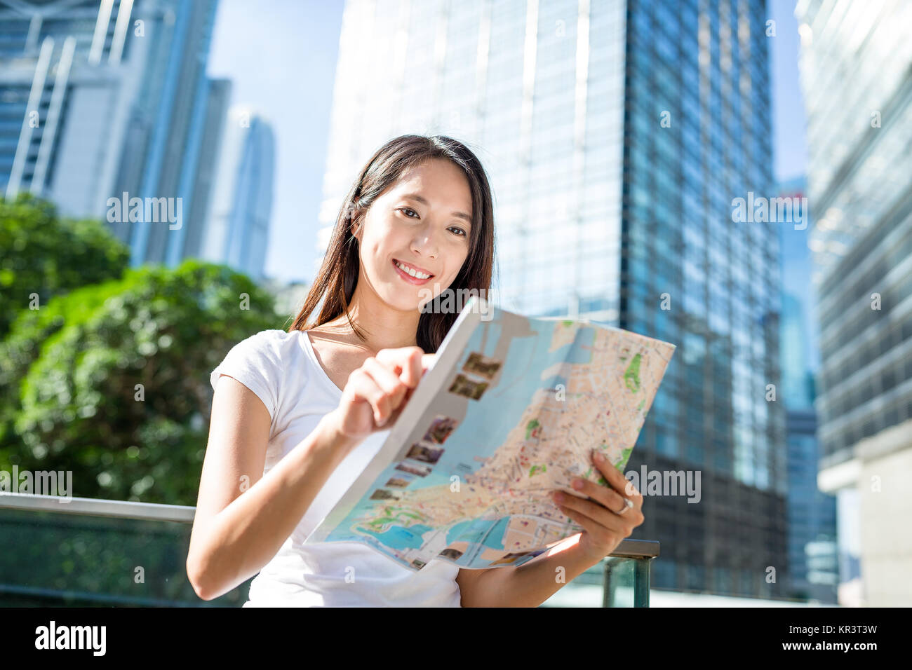 Asian woman reading on city map Stock Photo - Alamy