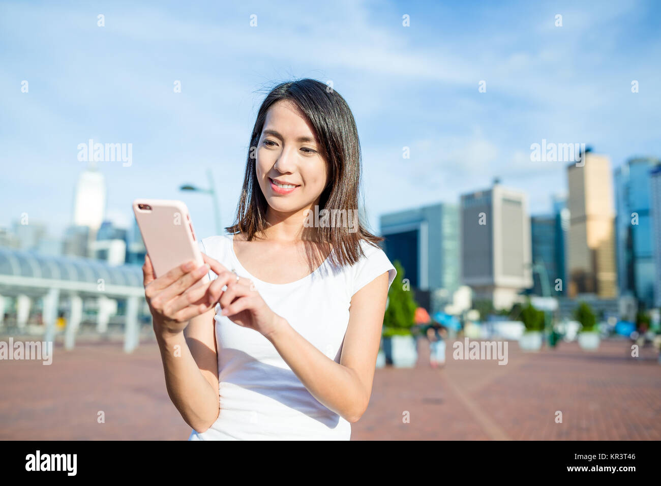 Asian woman use of mobile phone in Hong Kong city Stock Photo - Alamy