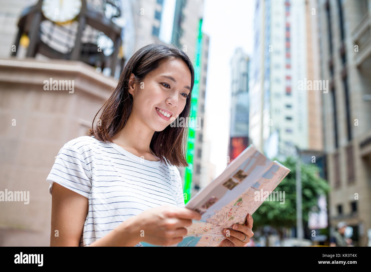 Woman finding the location on city map in Hong Kong Stock Photo - Alamy