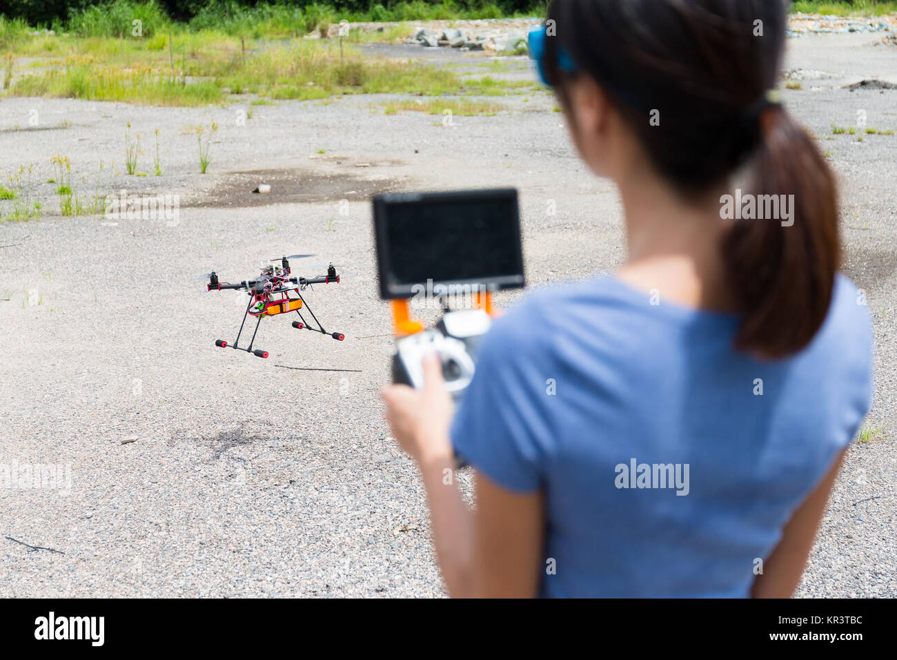 Woman flying drone Stock Photo - Alamy
