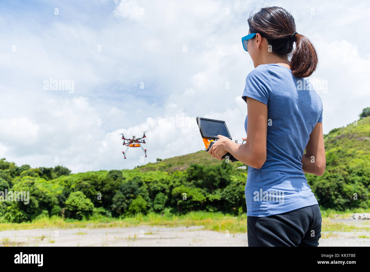 Woman playing with drone Stock Photo - Alamy