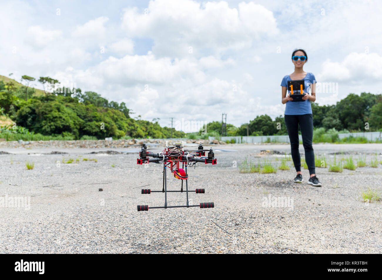 Asian female flying a drone hi-res stock photography and images - Alamy