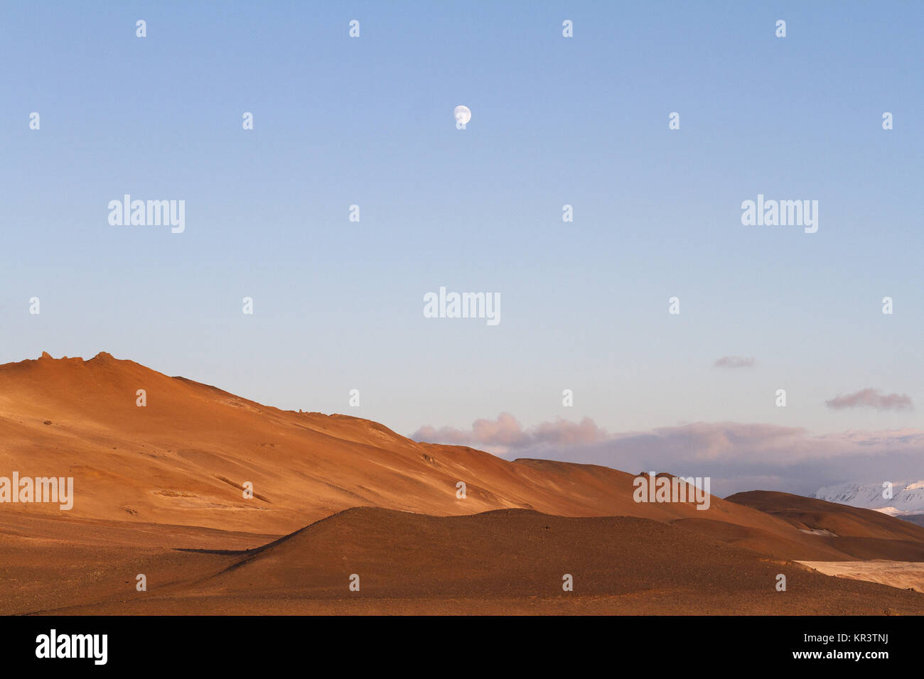 Red tinted volcanic mountains with moon rising above Stock Photo - Alamy
