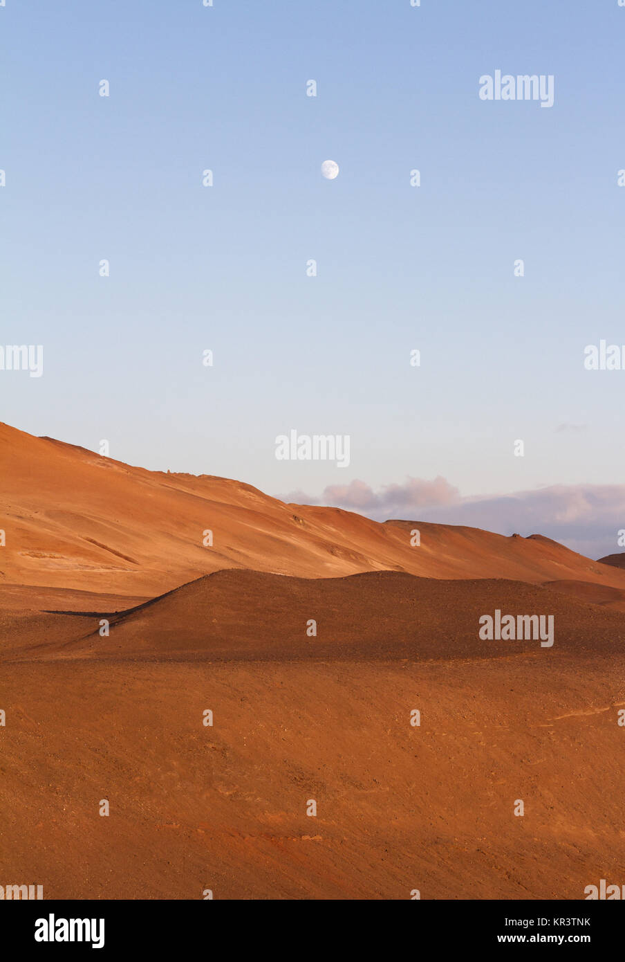 Red tinted volcanic mountains with moon rising above Stock Photo - Alamy