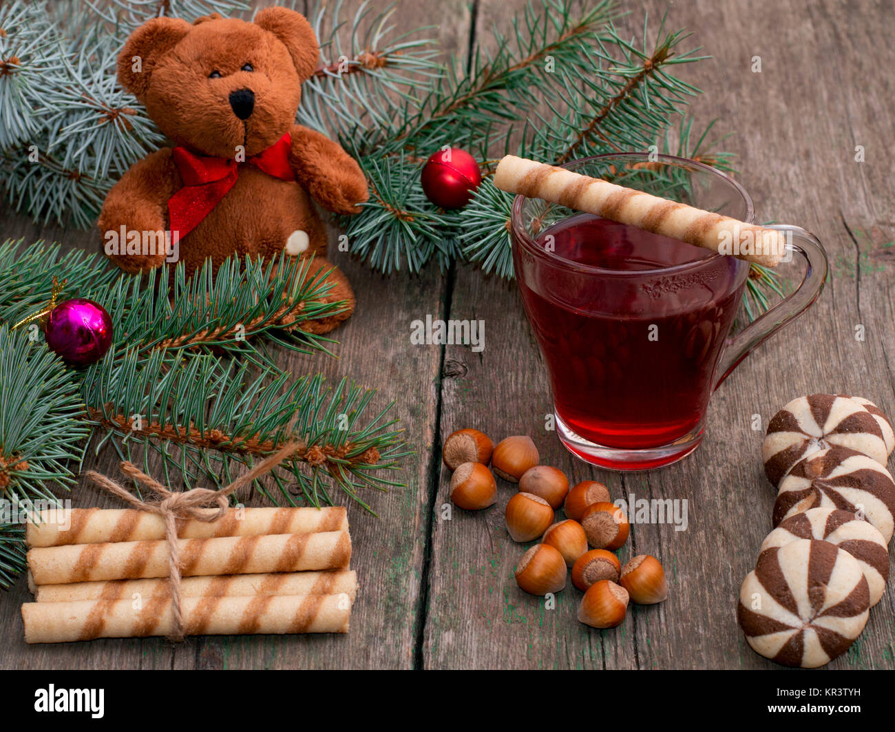fir-tree branch, toy bear, tea, baking and nutlets Stock Photo - Alamy