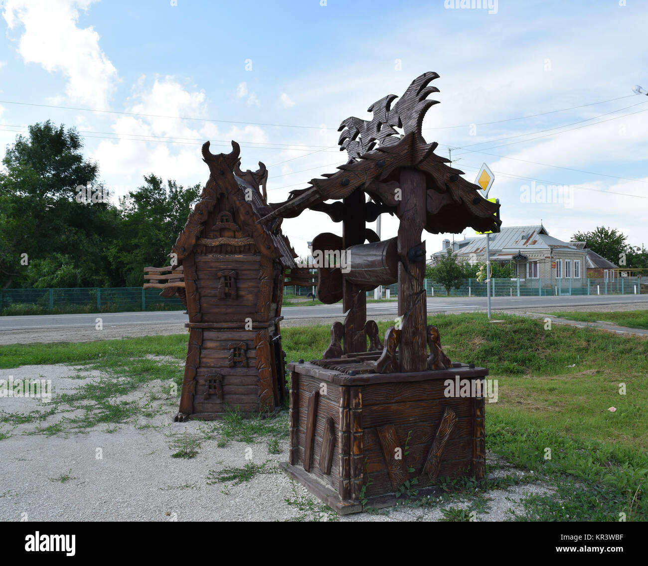 Wooden well and a windmill Stock Photo - Alamy