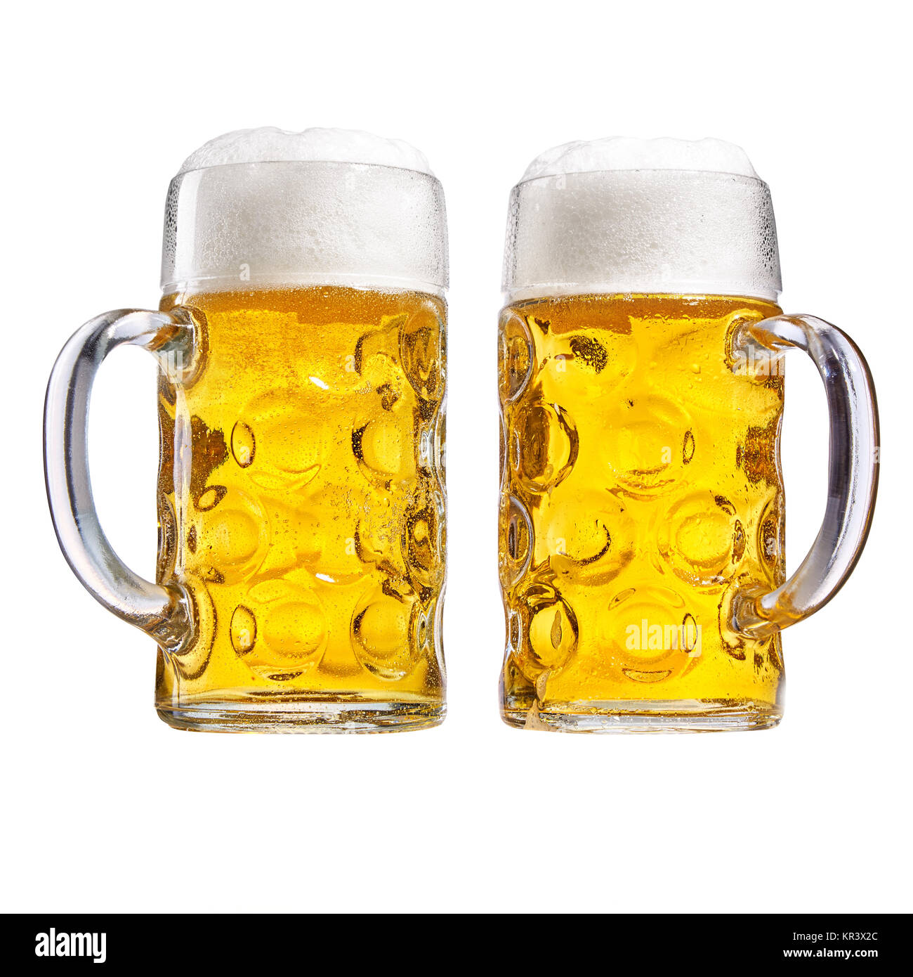 Two glass tankards of chilled beer with a good frothy head side by side ...