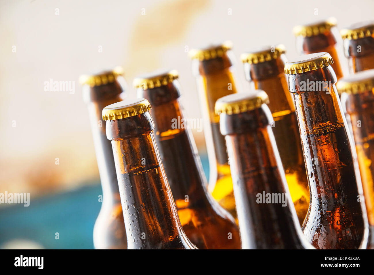 Chilled refreshing beers standing on a counter in a bar or pub with ...