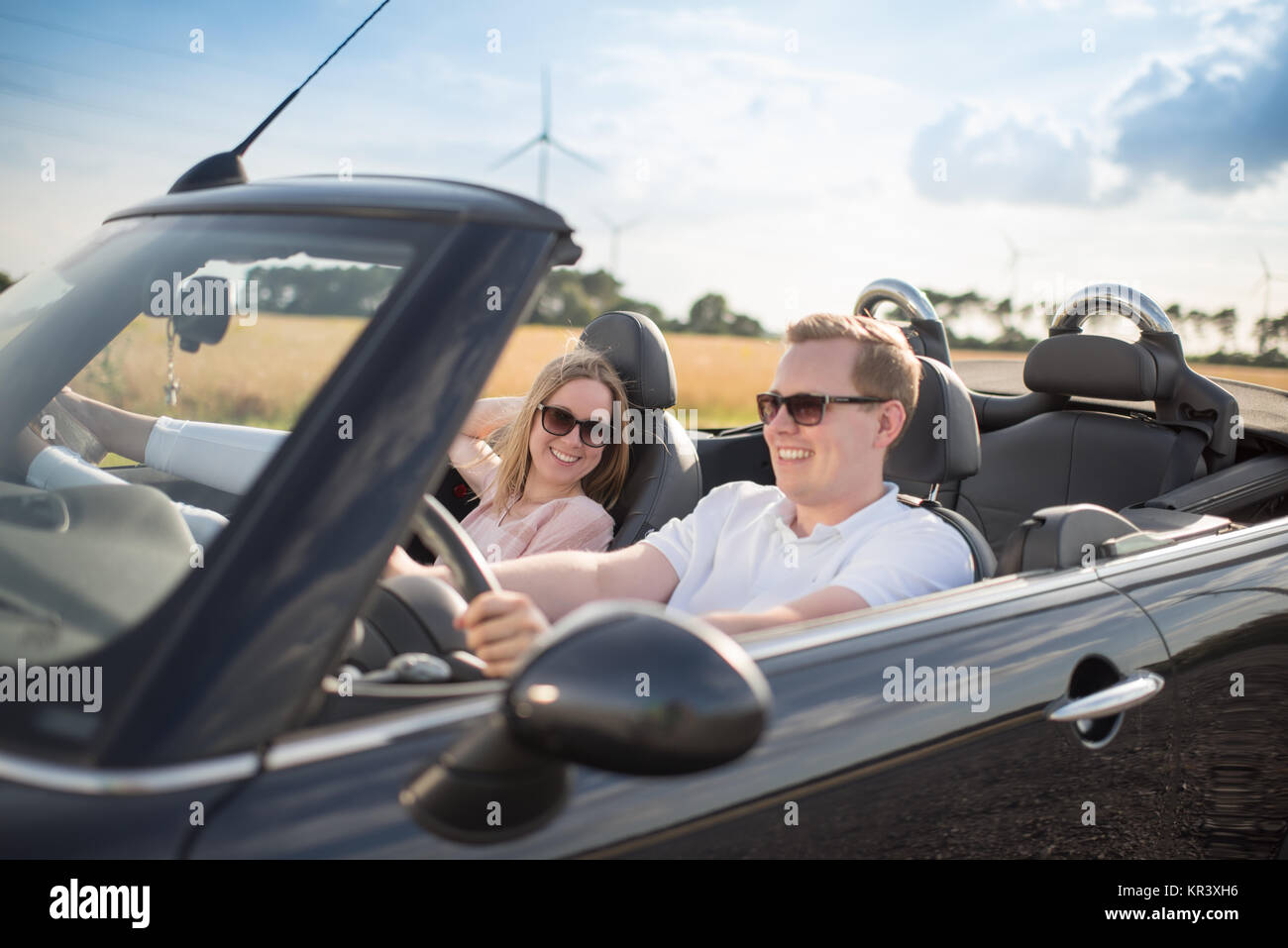 young loving couple in the convertible on the way Stock Photo - Alamy