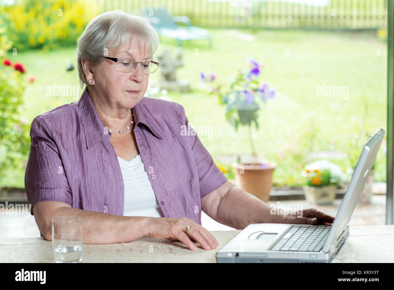 female senior is using computer at home Stock Photo - Alamy