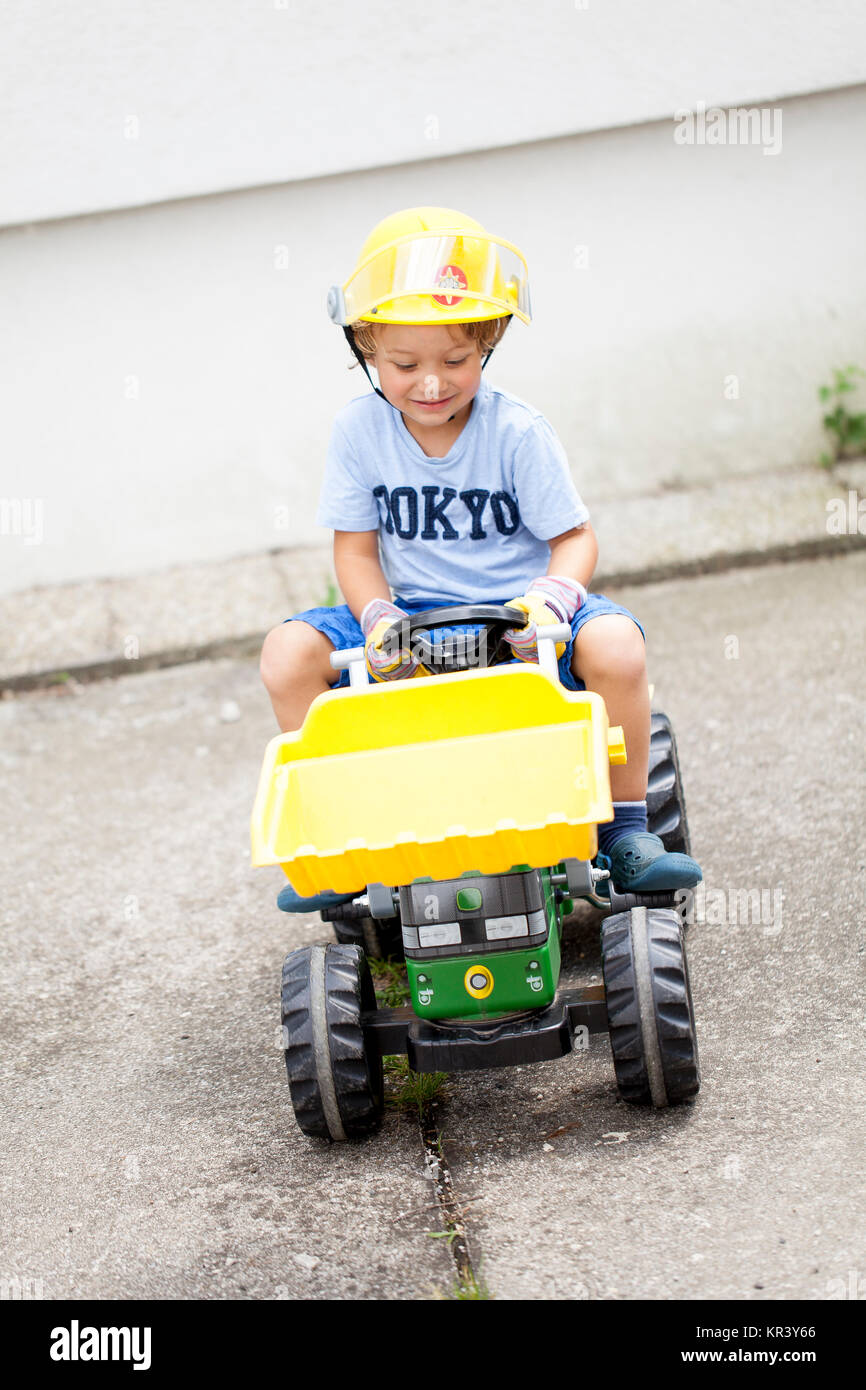 little boy on his toy tractor Stock Photo - Alamy