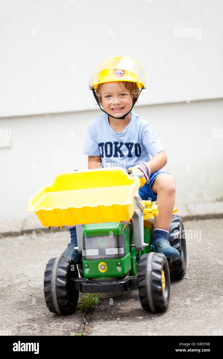 little boy on his toy tractor Stock Photo - Alamy
