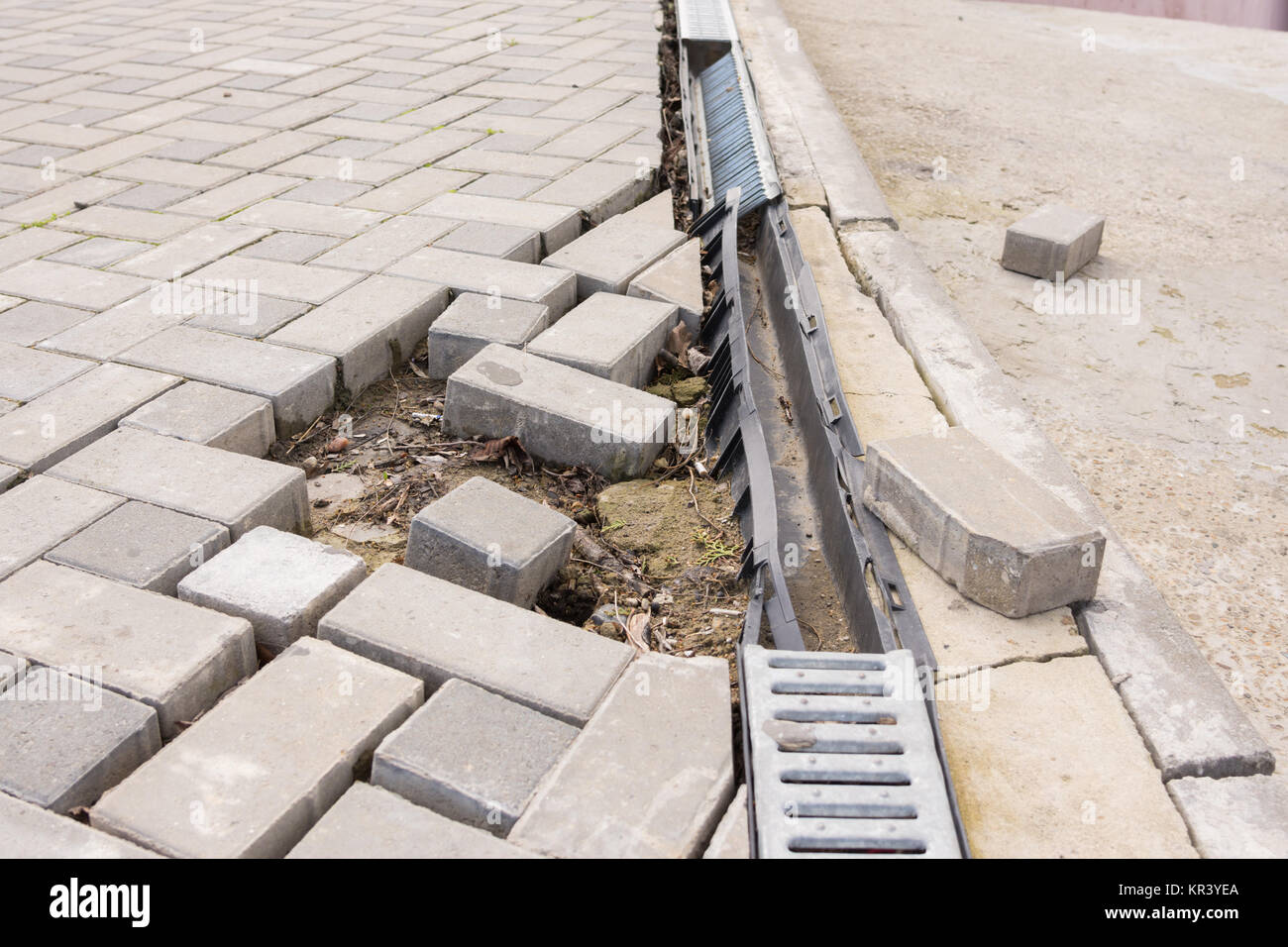 The destruction of the pedestrian walkway of paving with drainage and ...