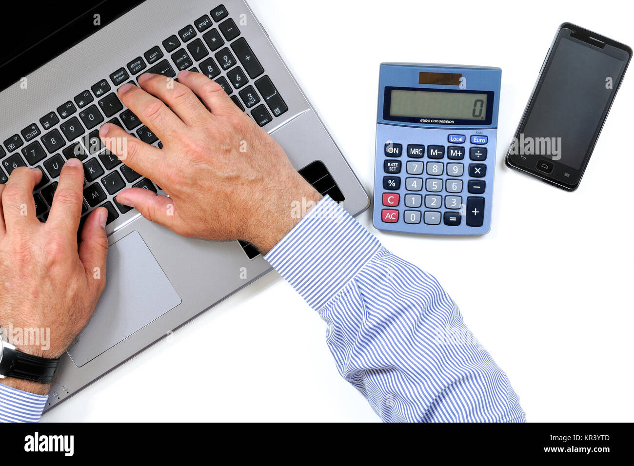 Top view of a man typing on a computer keyboard on the desk in a modern ...