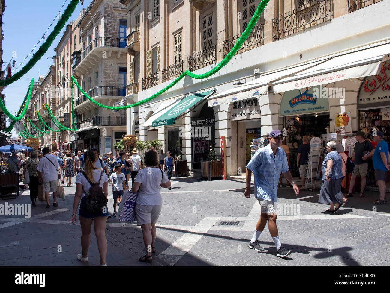 People walk one of the main shopping streets in Valletta city / Malta ...