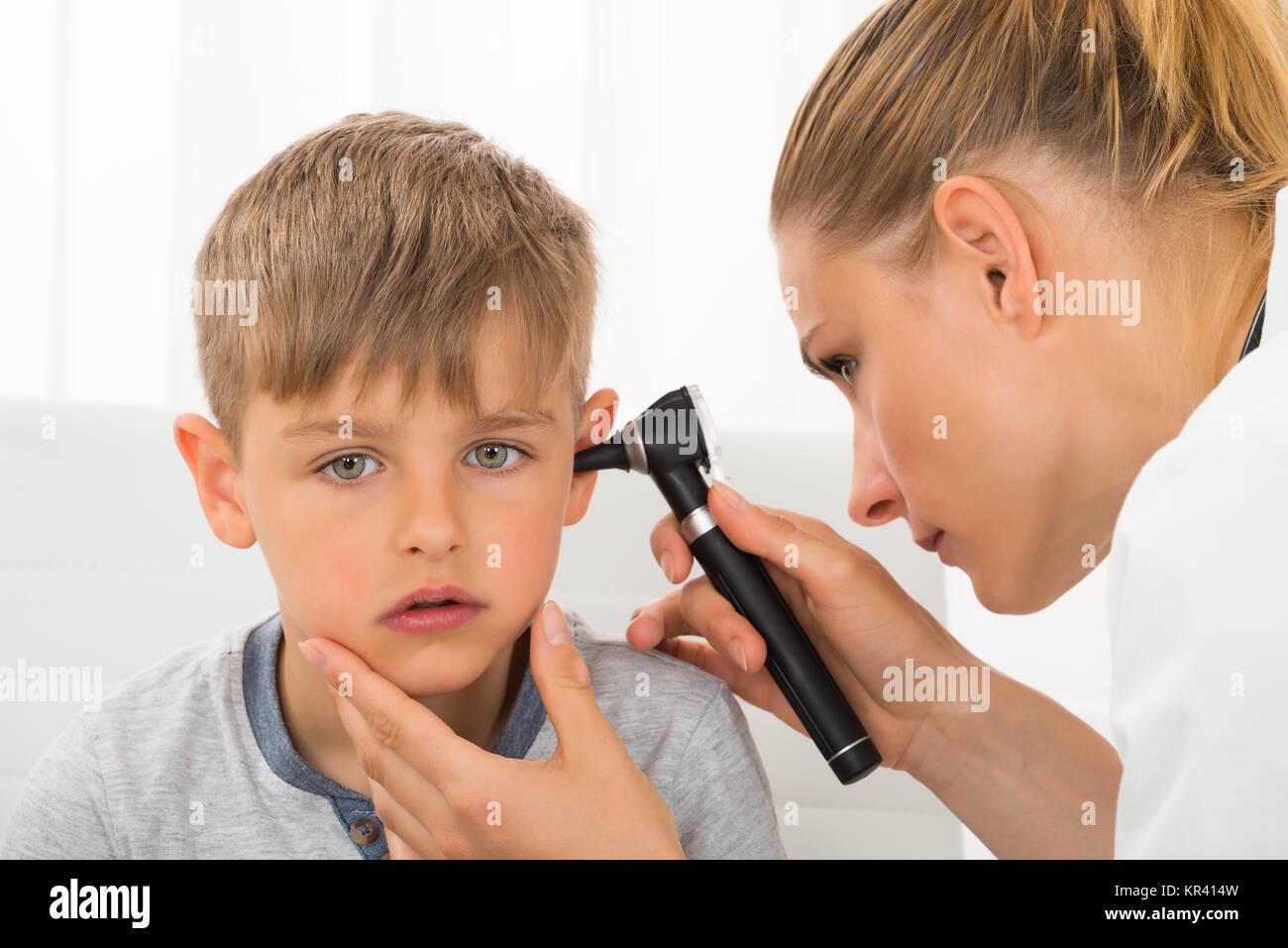 Doctor Examining Boy's Ear Stock Photo - Alamy