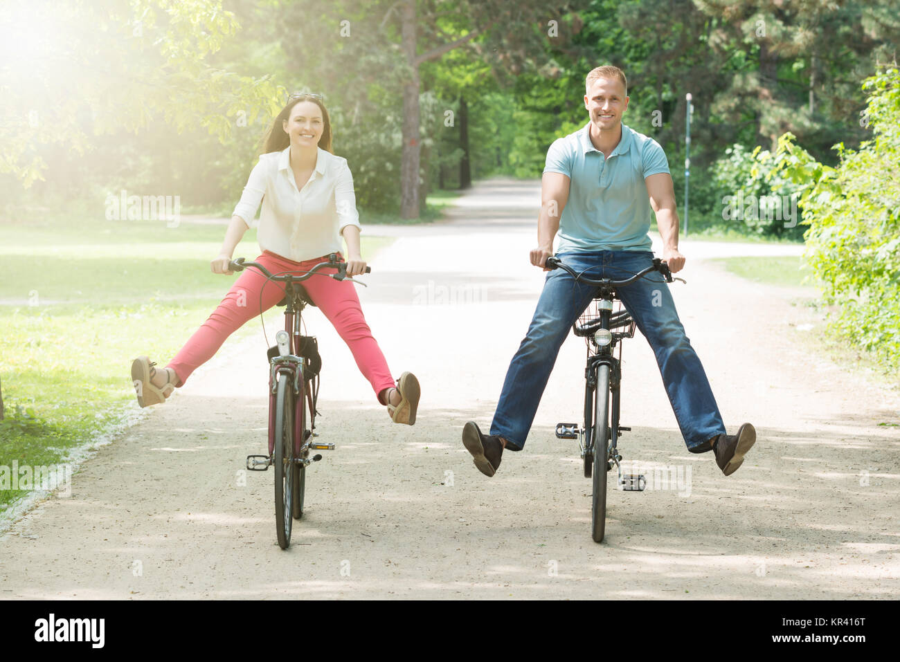 Happy Couple Riding Bicycle In Park Stock Photo - Alamy