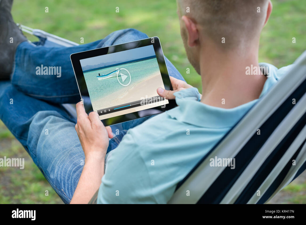 Man Watching Video On Digital Tablet Stock Photo - Alamy