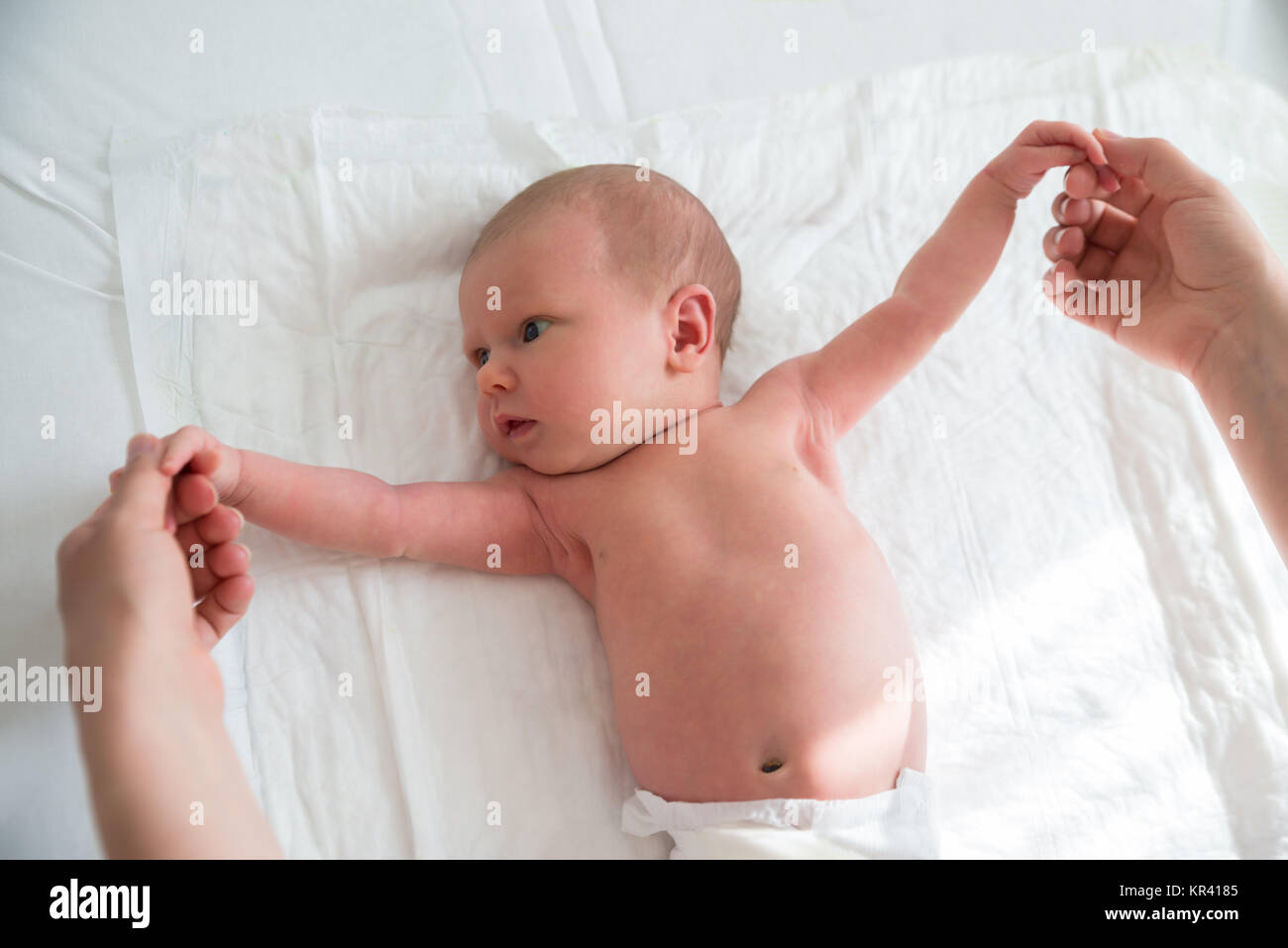 Mother Holding Baby's Hand Stock Photo - Alamy