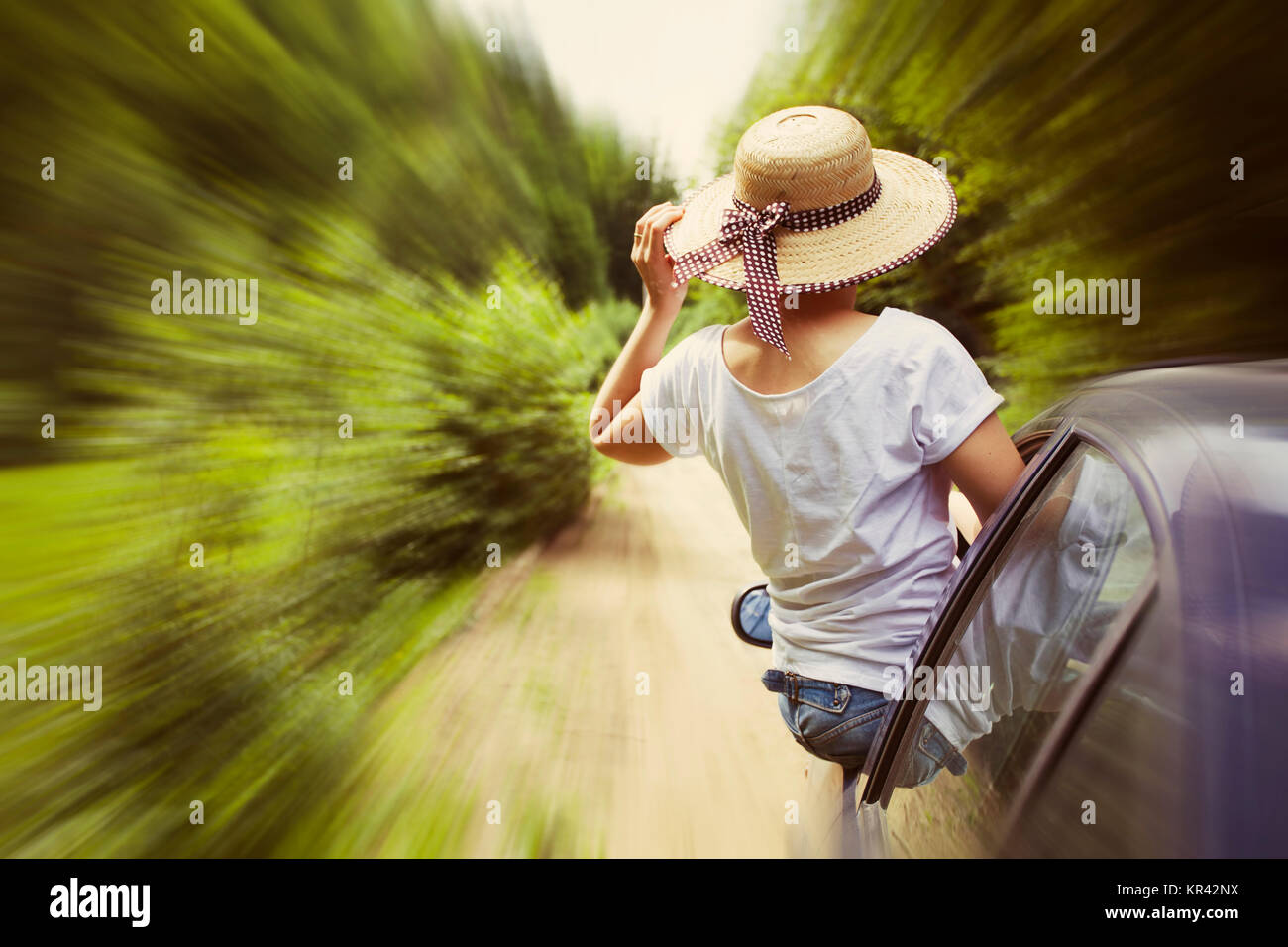 Young girl siting in a car's window Stock Photo - Alamy