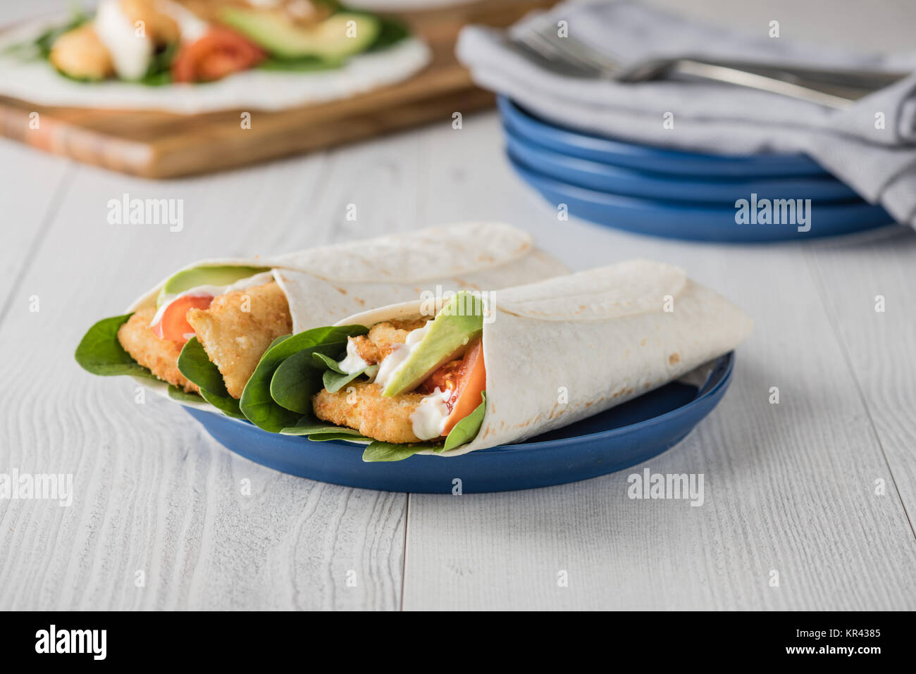 Fish finger wraps with avocado and tomato Stock Photo - Alamy
