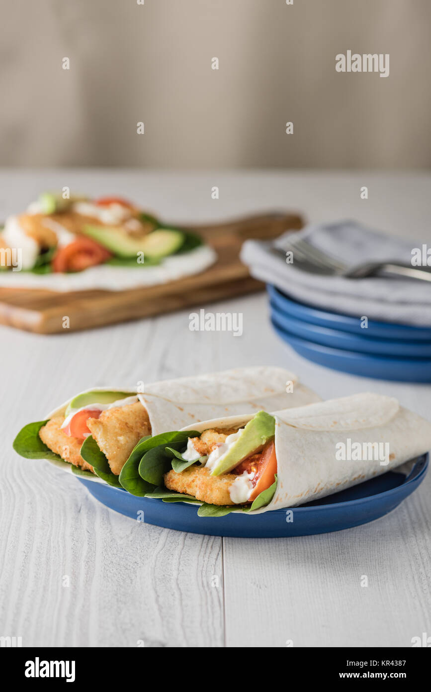 Fish finger wraps with avocado and tomato Stock Photo - Alamy