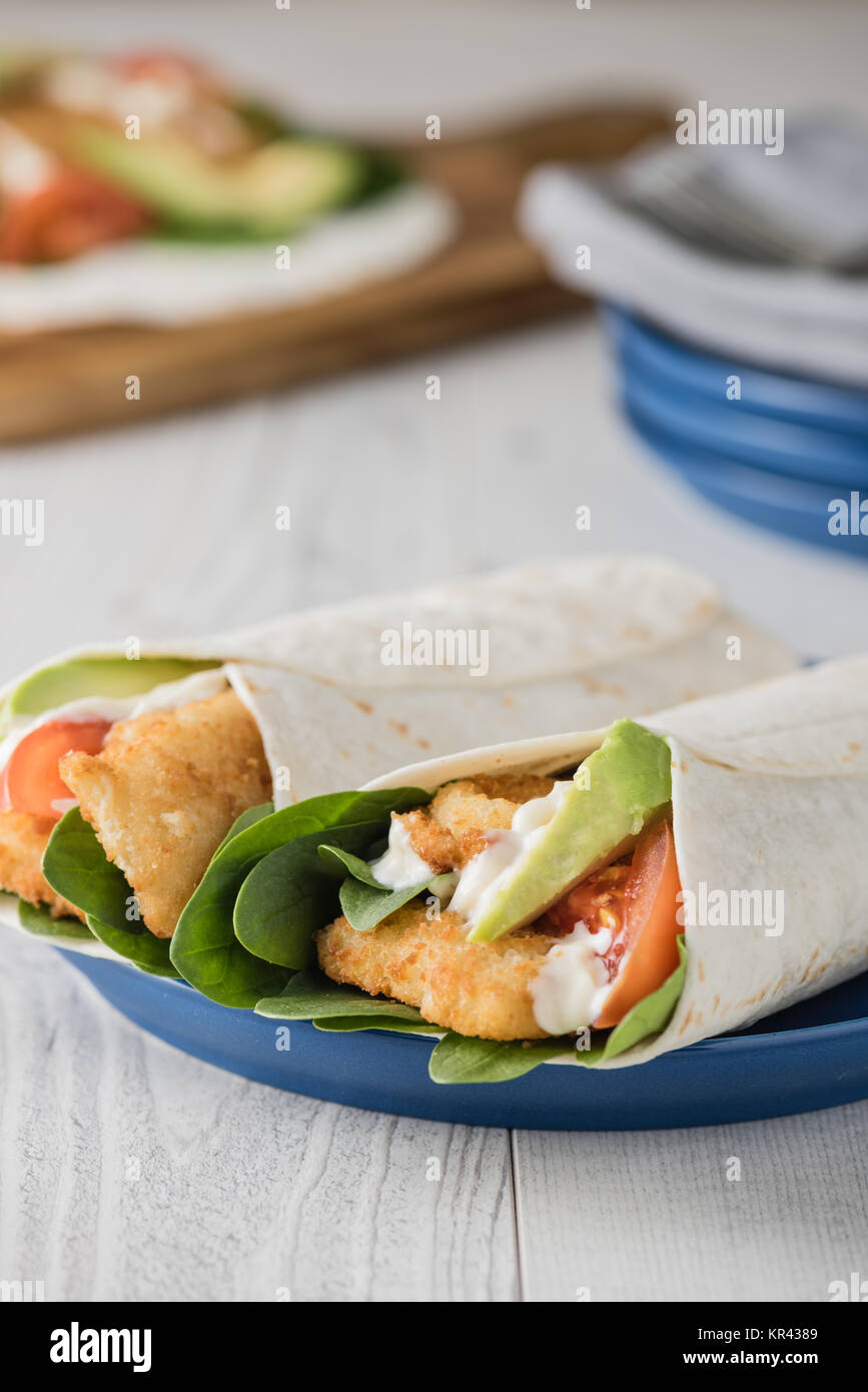 Fish finger wraps with avocado and tomato Stock Photo - Alamy
