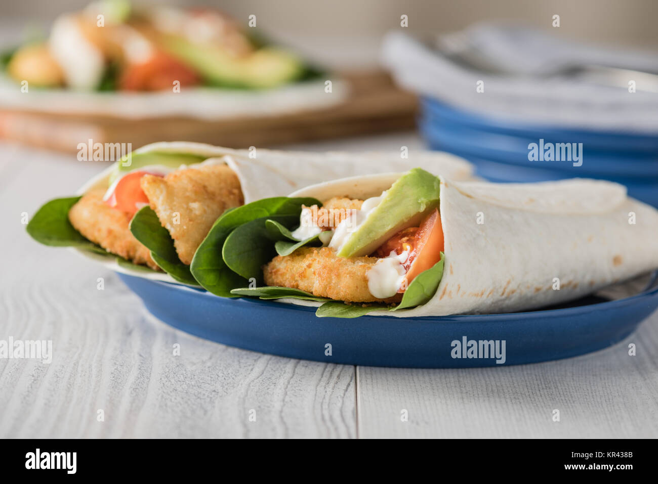 Fish finger wraps with avocado and tomato Stock Photo - Alamy