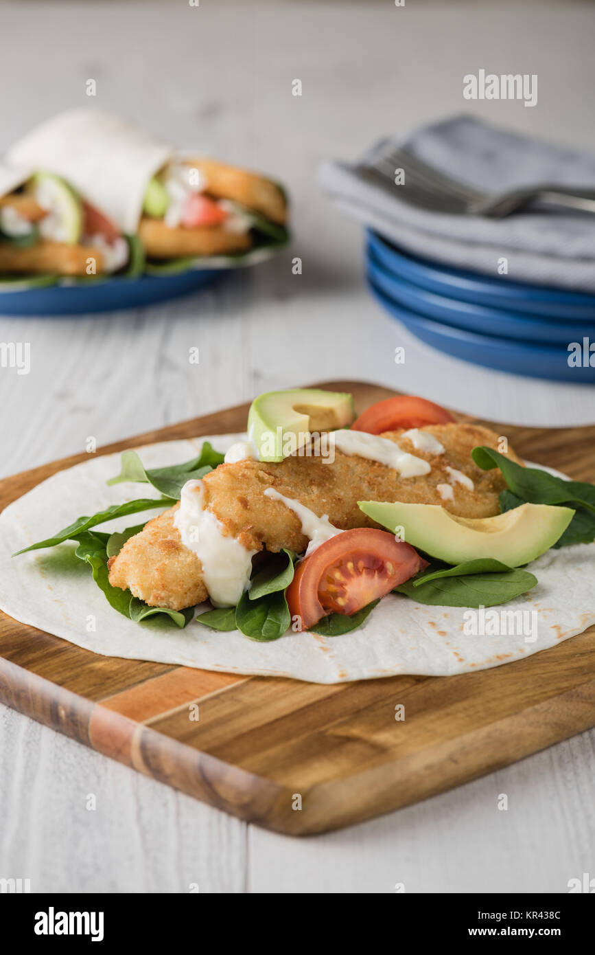 Fish finger wraps with avocado and tomato Stock Photo - Alamy