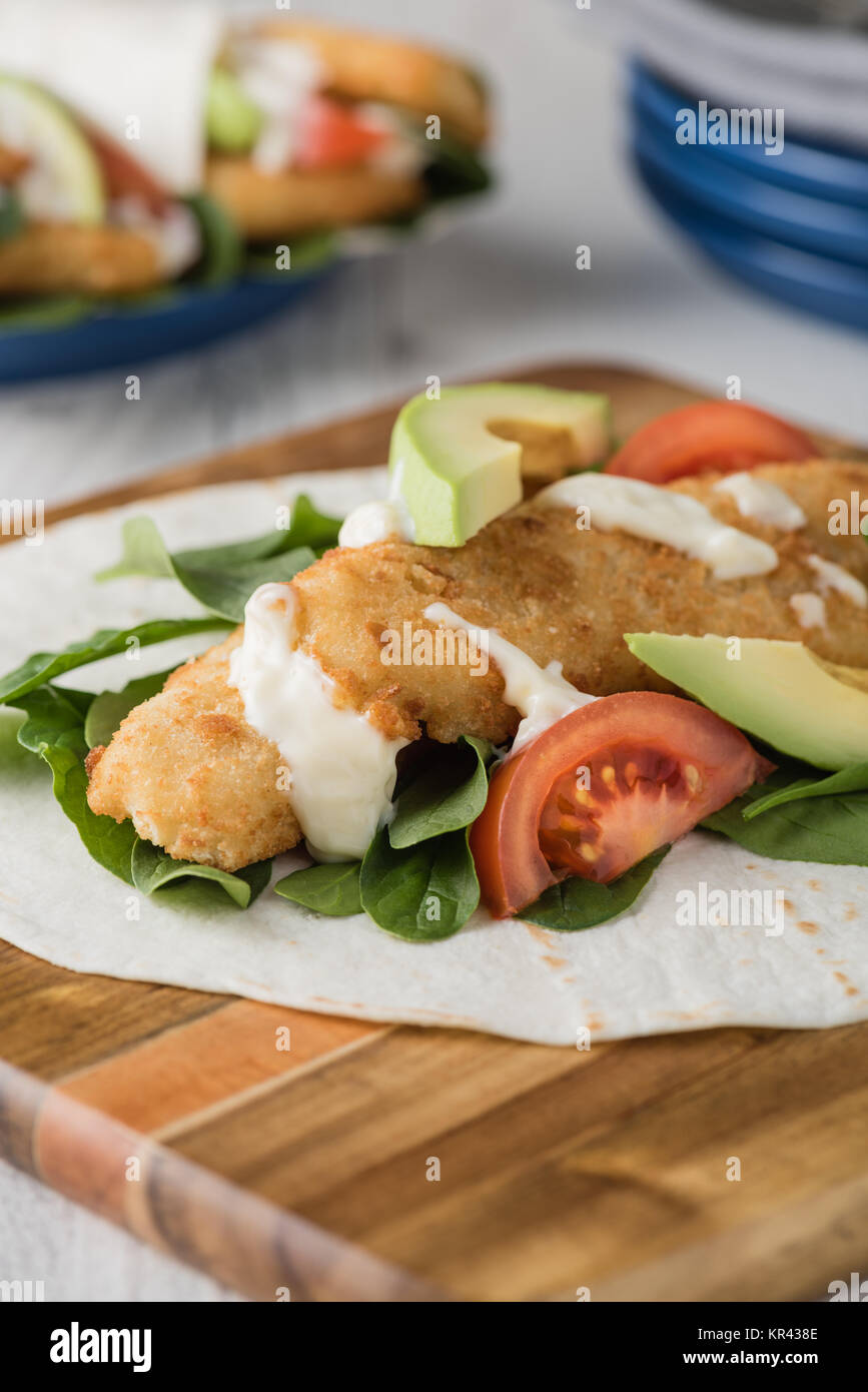 Fish finger wraps with avocado and tomato Stock Photo - Alamy