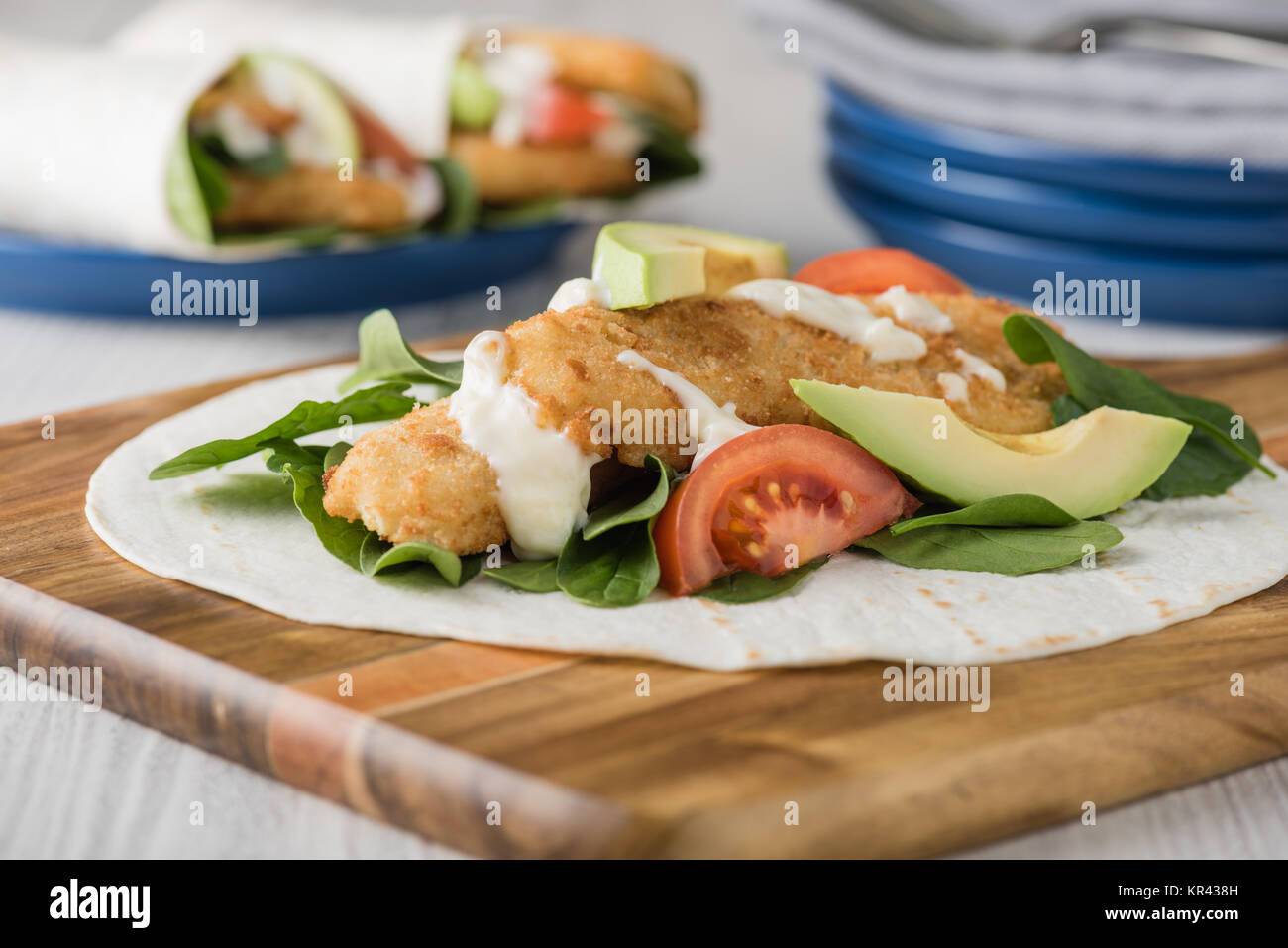 Fish finger wraps with avocado and tomato Stock Photo - Alamy