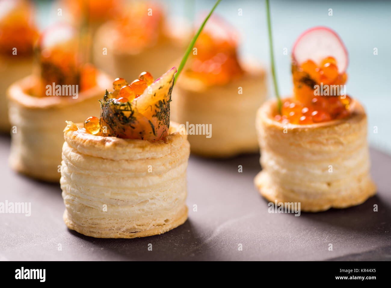 Delicious appetizers with graved salmon and golden caviar served in ...