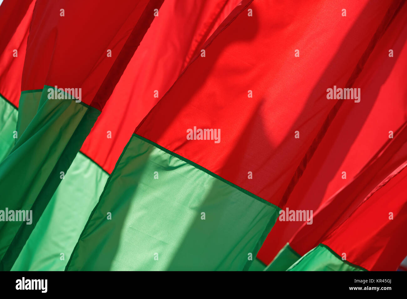 Bright red flags drape hi-res stock photography and images - Alamy