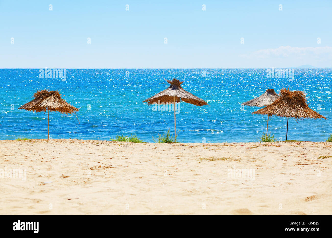 Straw beach umbrellas Stock Photo - Alamy