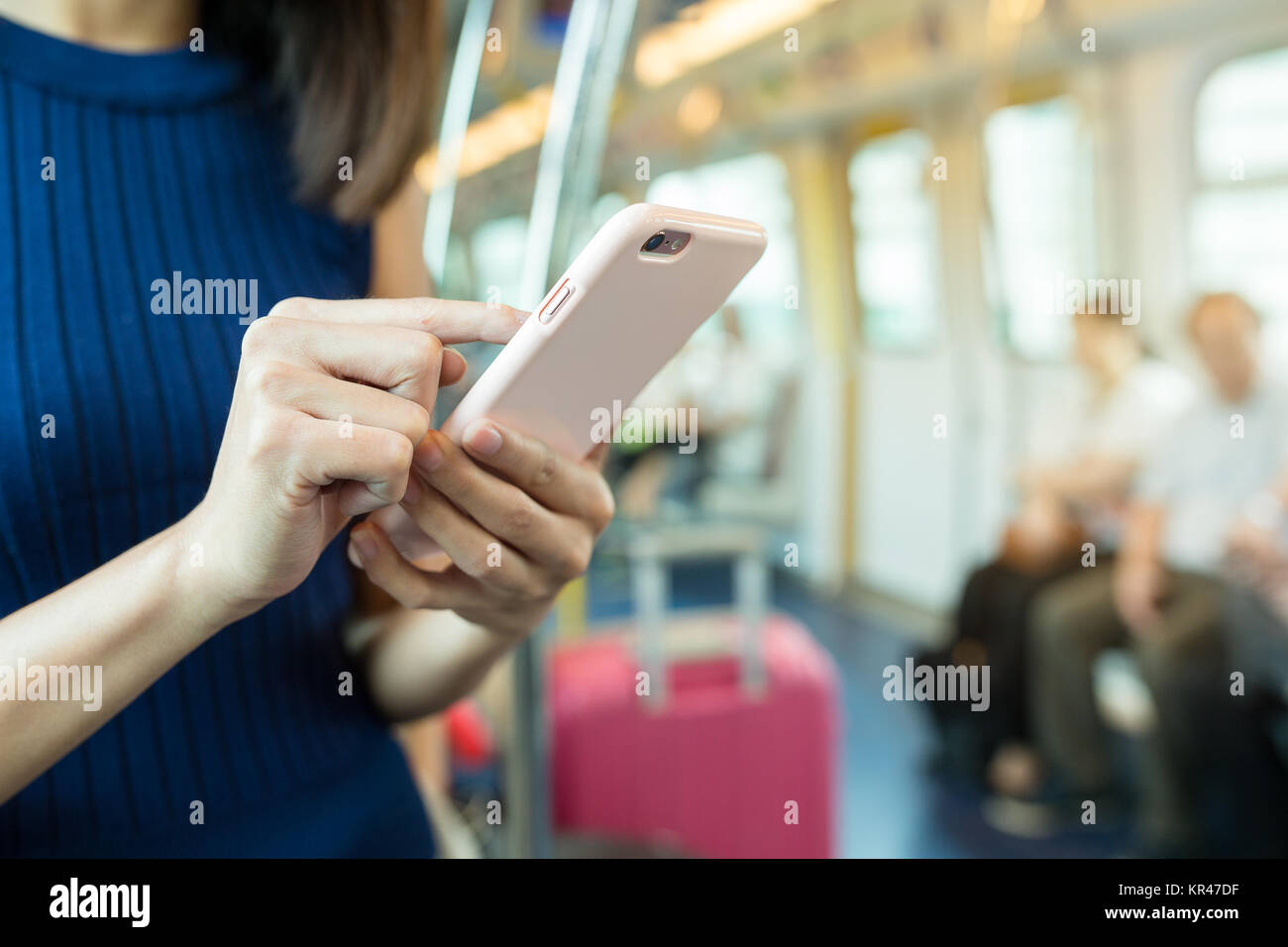 Woman using cellphone inside train compartment Stock Photo - Alamy