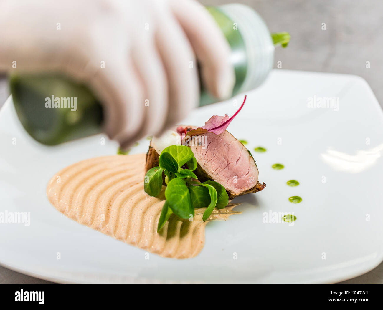 Chef finishing her plate Stock Photo - Alamy